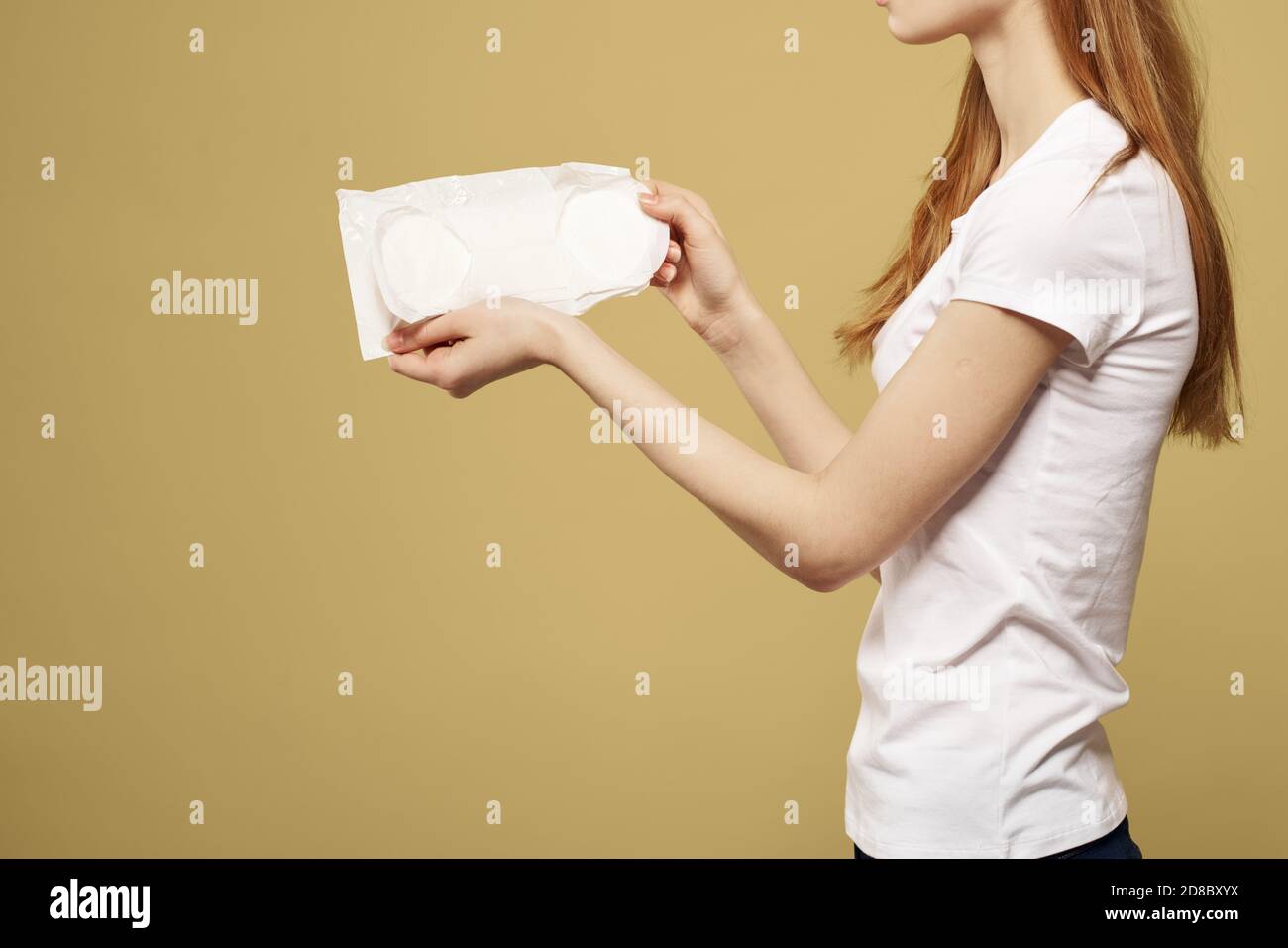 Woman with pad in hand on beige background cropped side view Stock ...