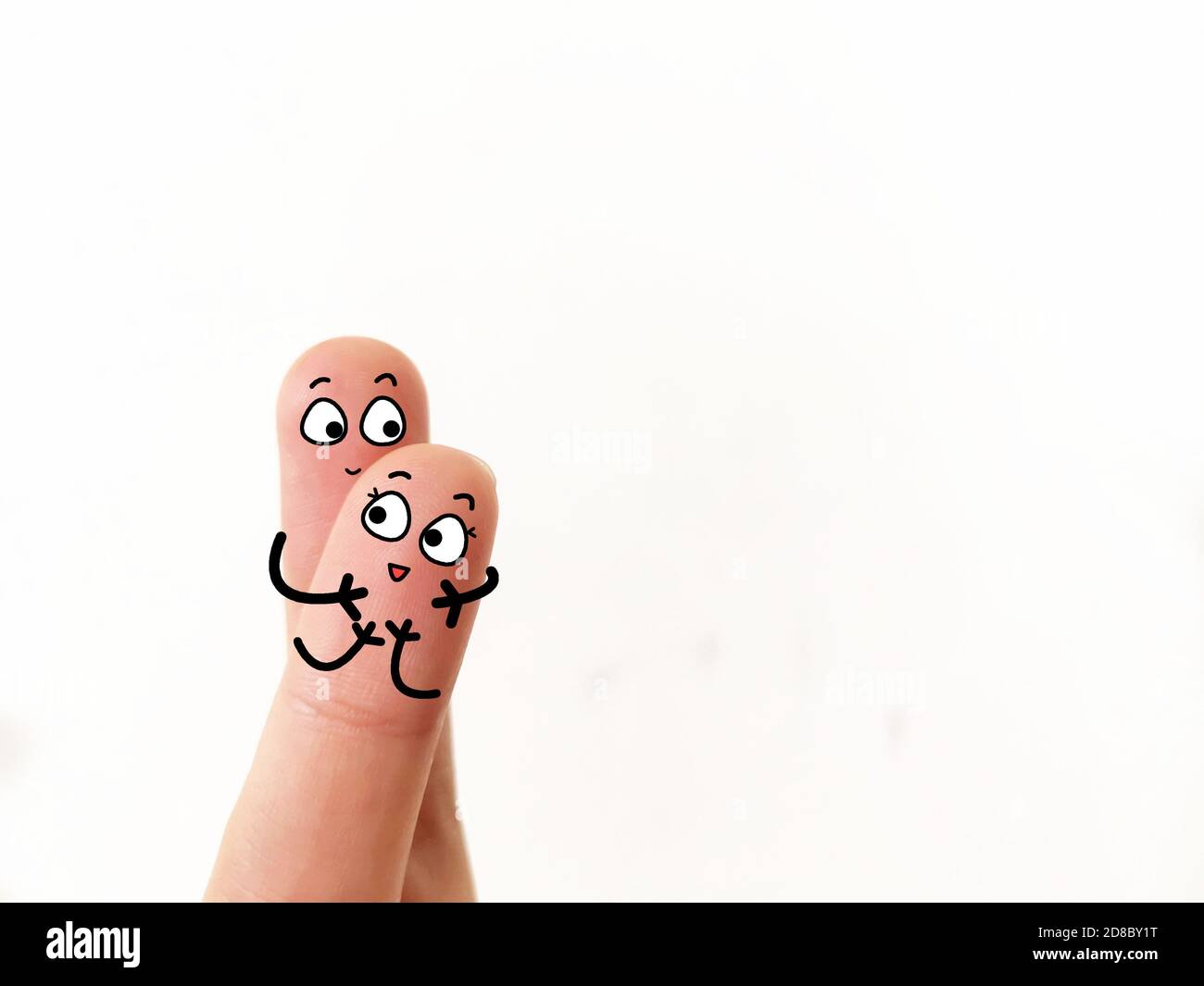 Two fingers are decorated as two person. A man is hugging a woman Stock ...