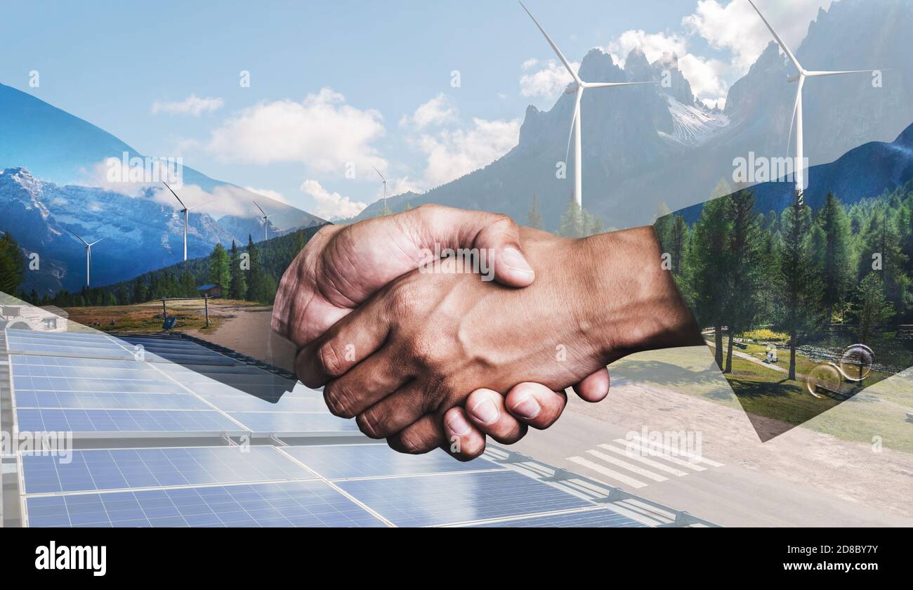 Double exposure graphic of business people handshake over wind turbine ...
