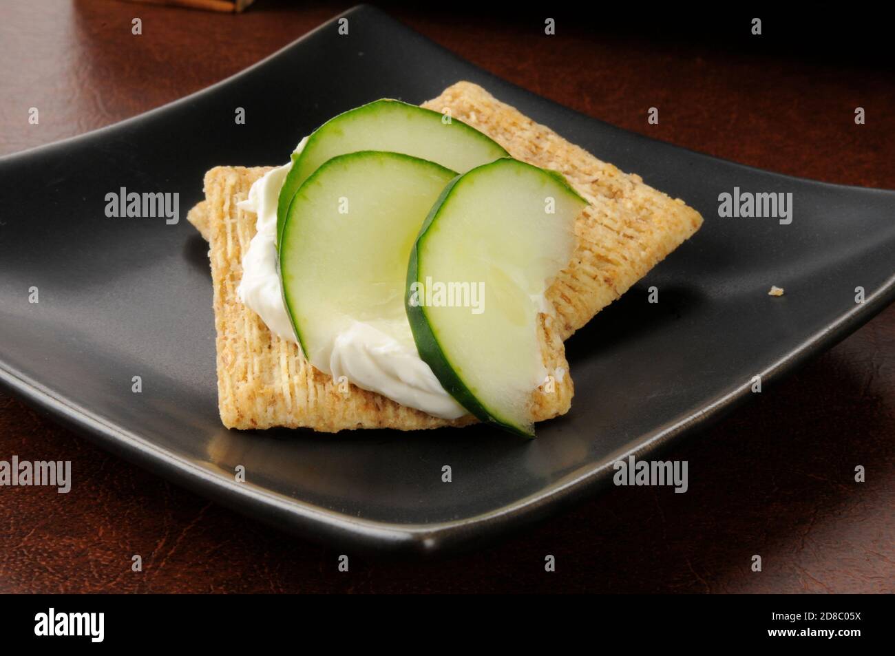 Cream cheese and cucumbers on shredded wheat crackers Stock Photo - Alamy