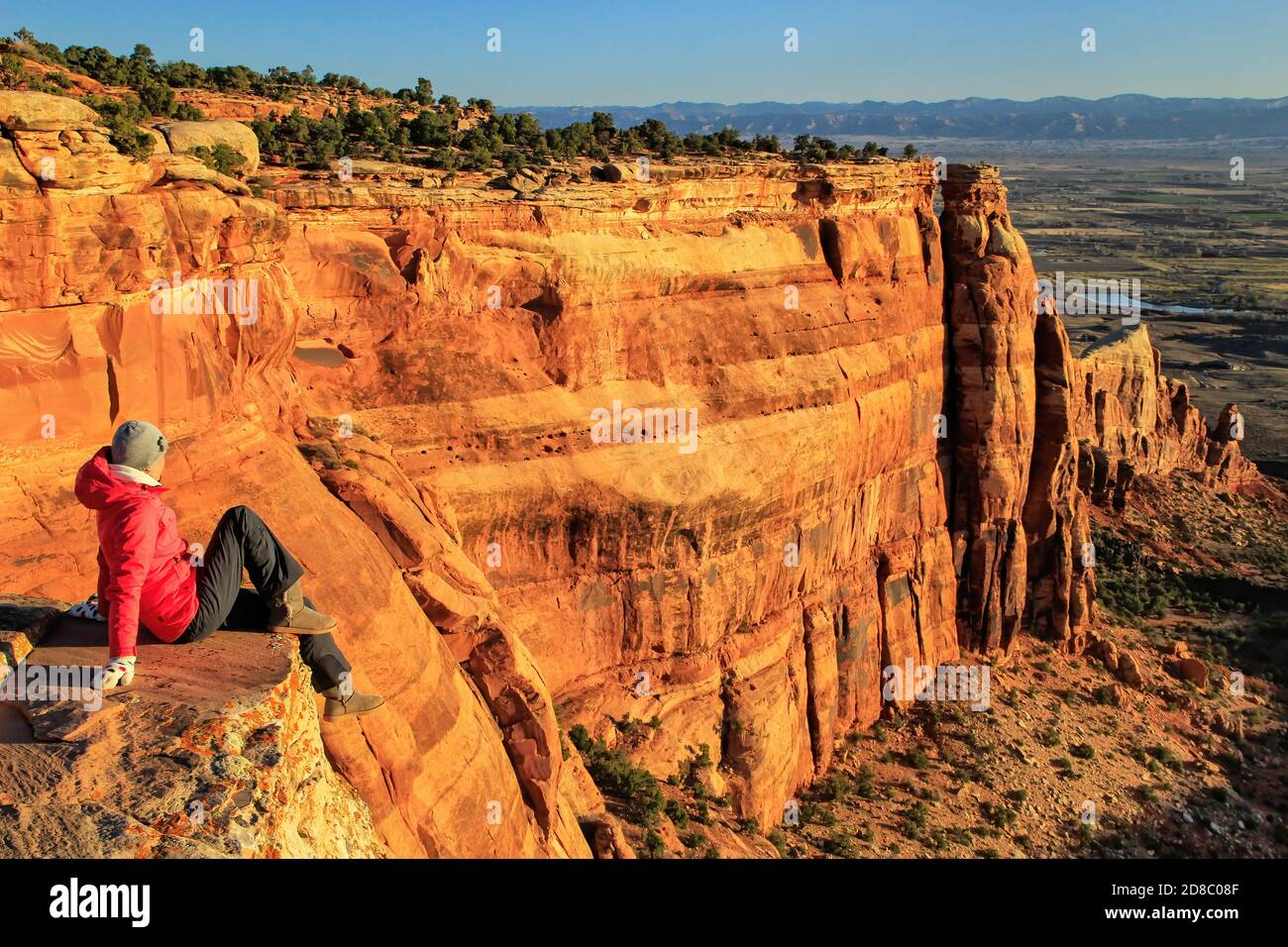 Woman enjoying the view of Window Rock in Colorado National Monument ...
