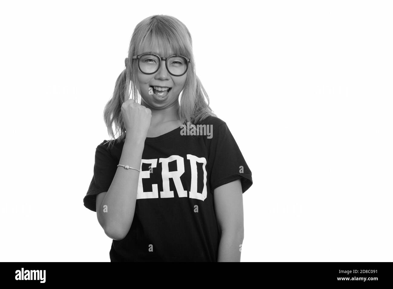Young happy Asian nerd woman smiling and looking motivated Stock Photo ...
