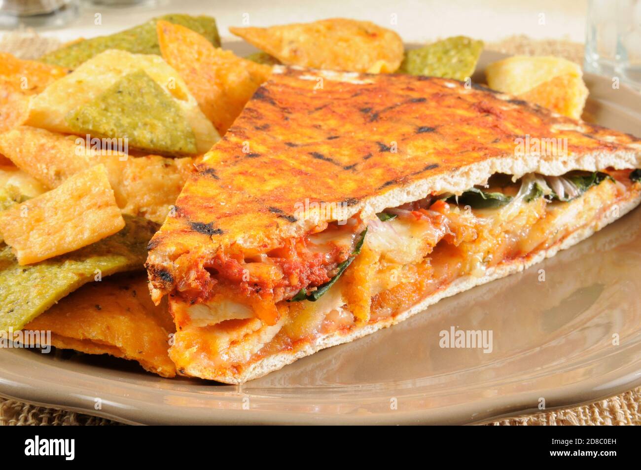 A spicy grilled chicken panini on flatbread with vegetable tortilla ...