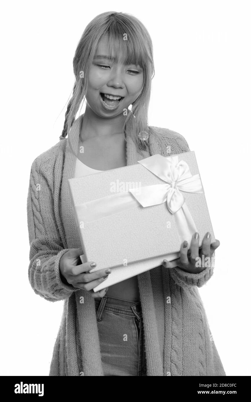 Young happy Asian woman smiling and opening gift box Stock Photo - Alamy