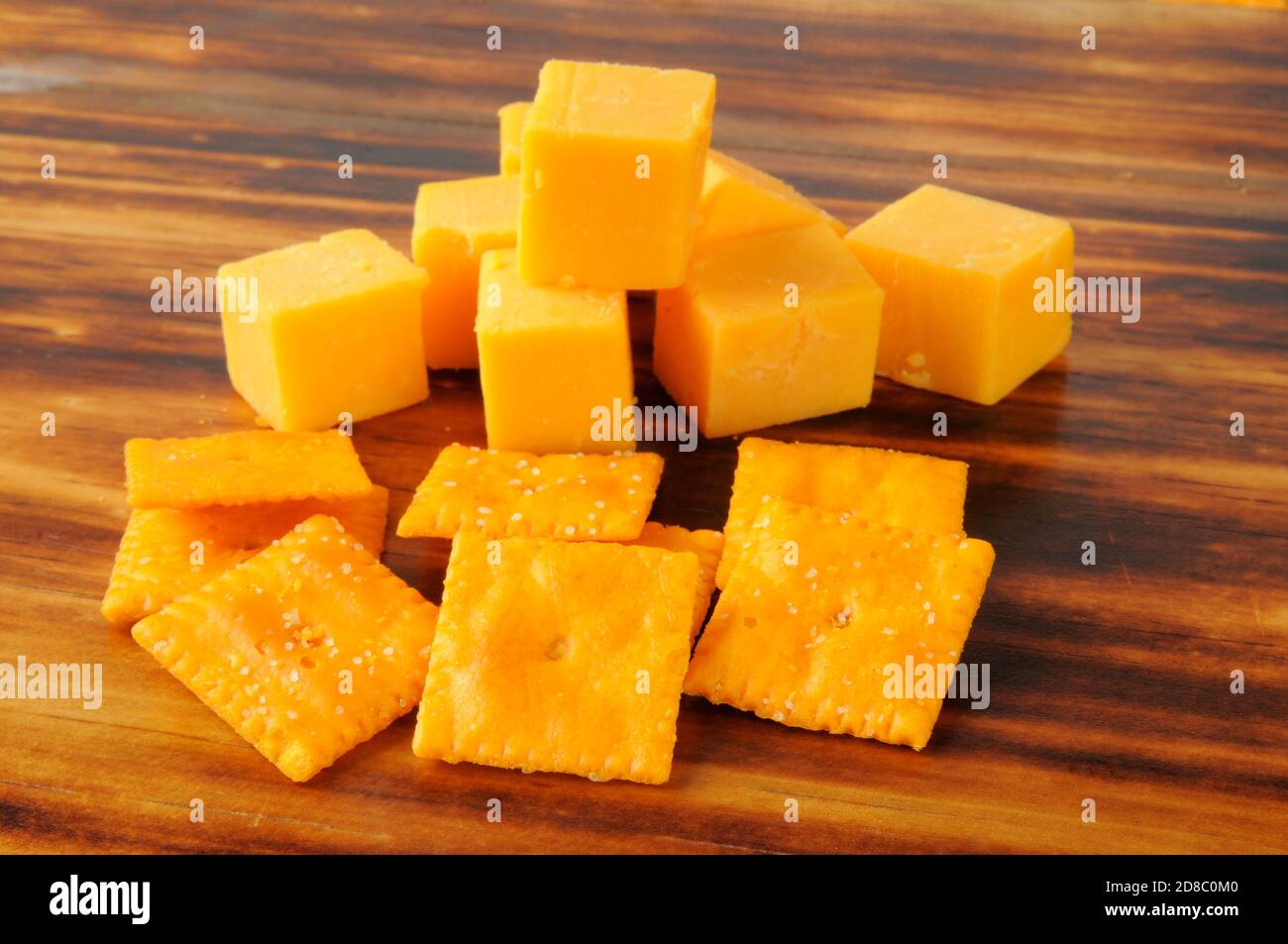 Cheesy crackers with cheddar cheese cubes Stock Photo - Alamy