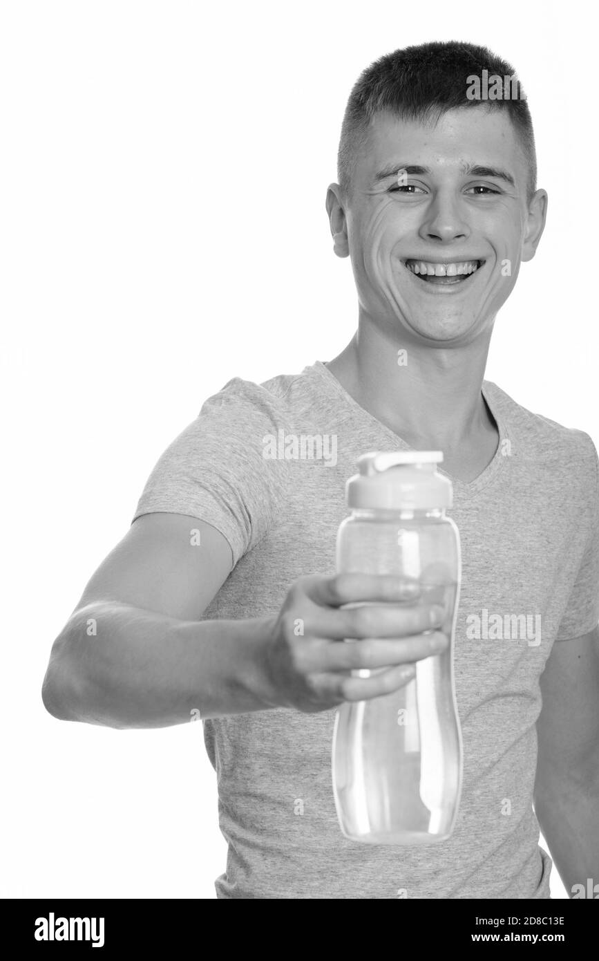 Young happy Caucasian man smiling and giving water bottle Stock Photo ...