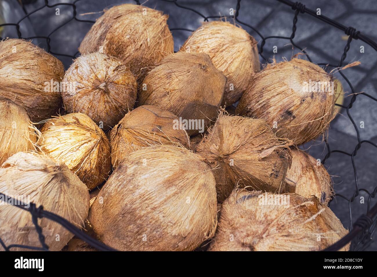 Group of coconuts with shell in a basket at the market. Photo with ...