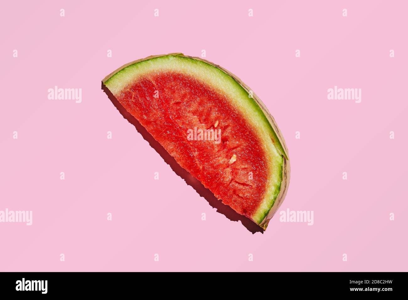 Slice of Mini Watermelon isolated on pink background with hard shadow ...