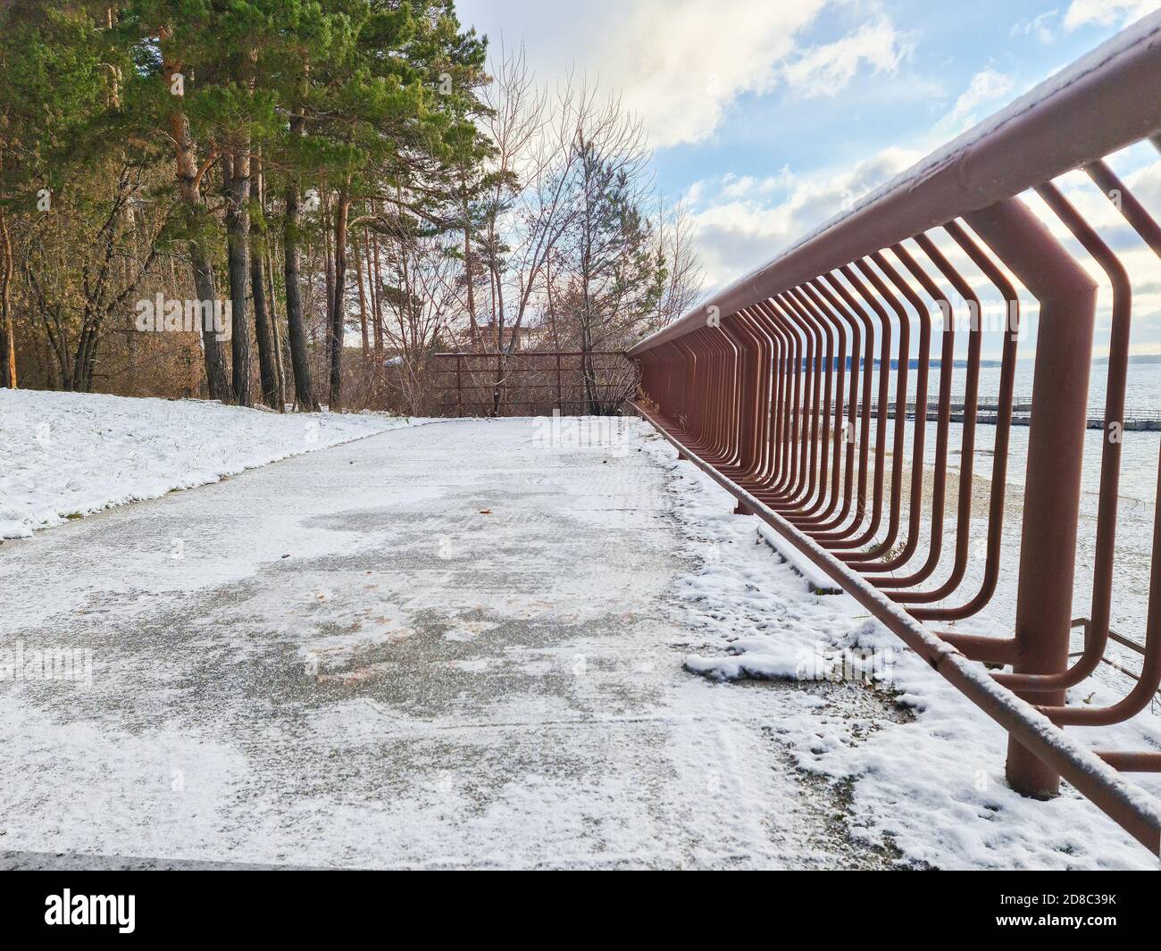 Winter landscape of the embankment by the river with a view of the ...