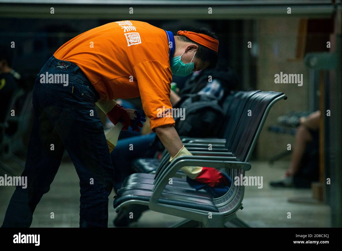 Taipei, Taiwan. 4th Apr, 2020. A worker wearing a face mask cleans the ...