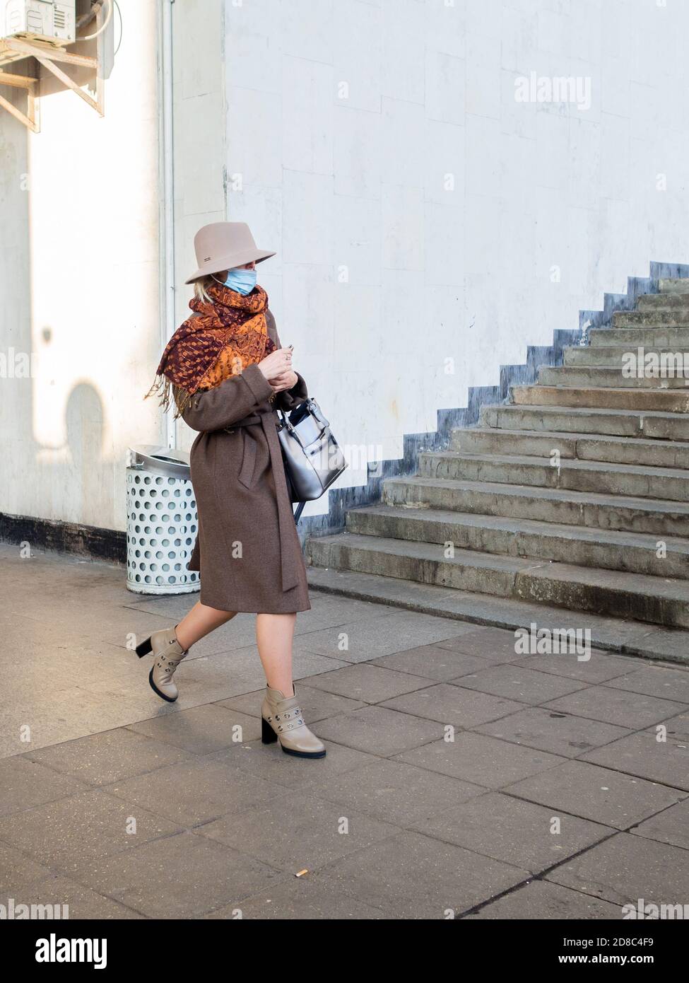 Moscow. Russia. October 28, 2020. A woman in a hat and a protective ...