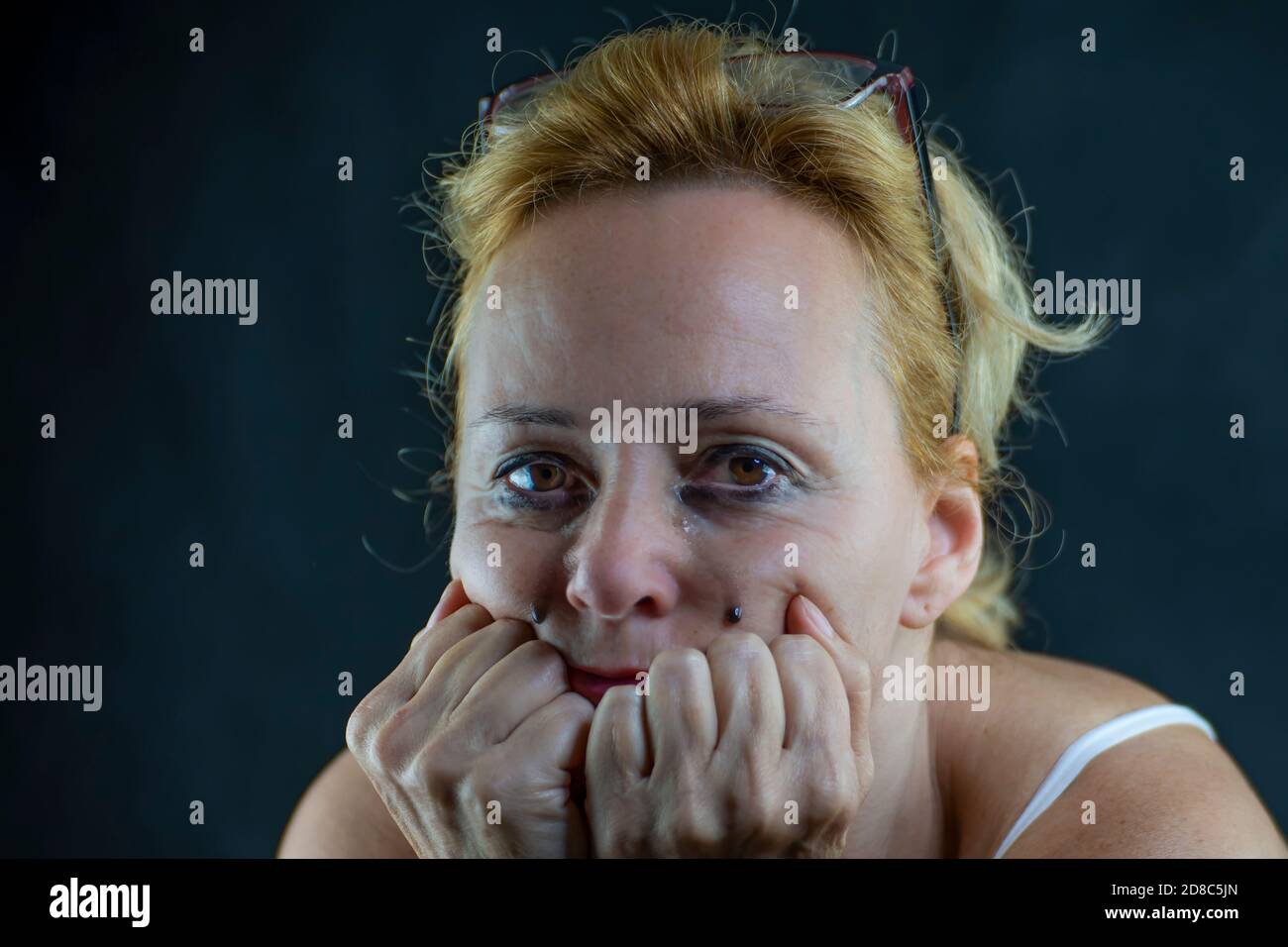 Portrait of a middle-aged white woman crying in pain and despair, with ...