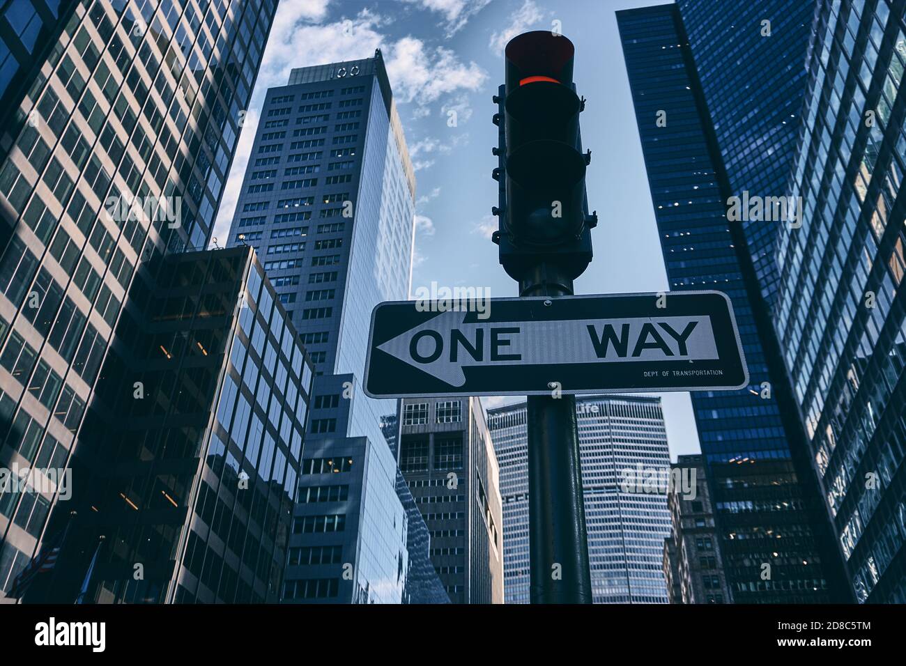 One Way banner under the traffic lights with modern skyscrapers in the ...
