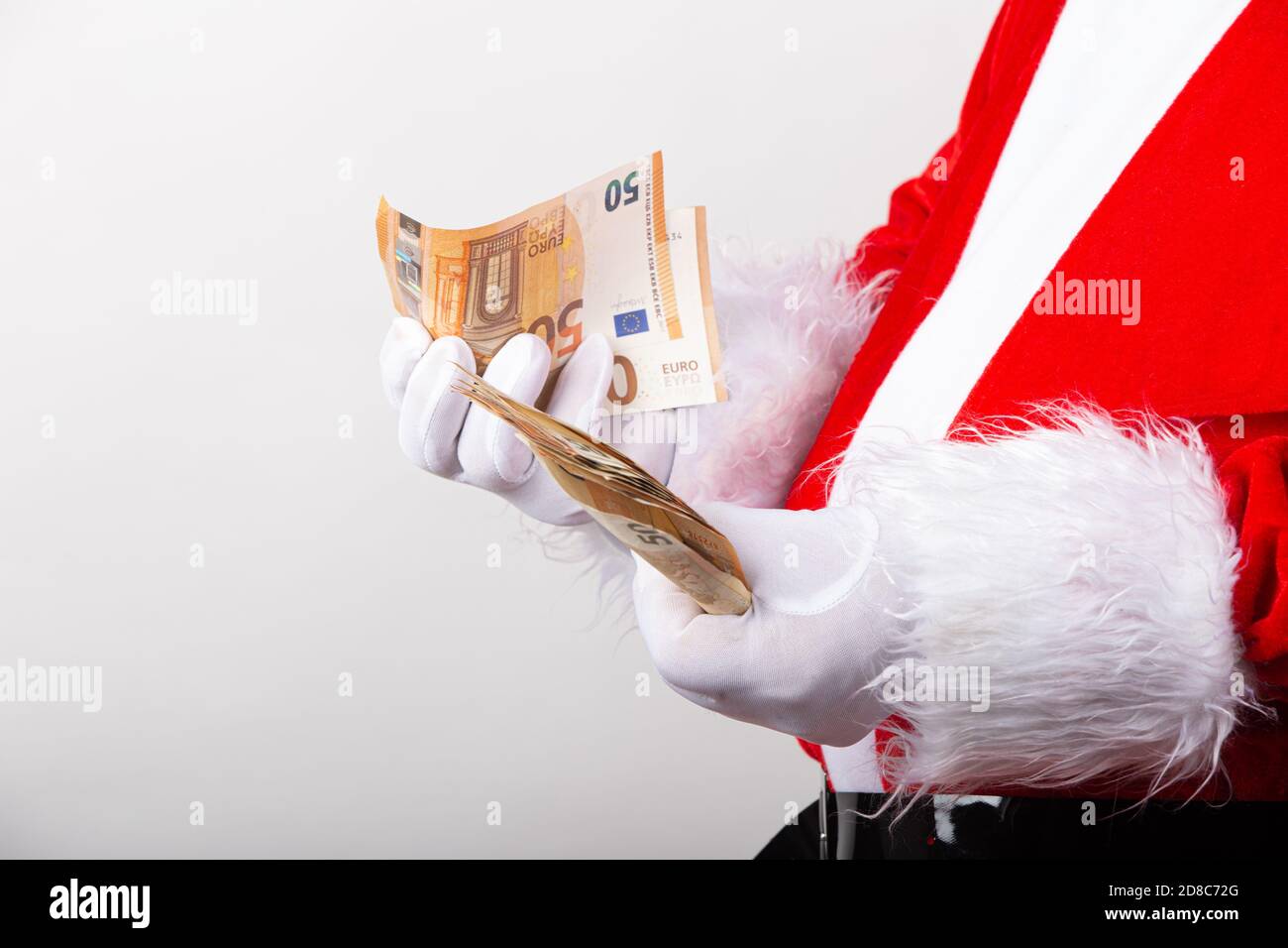 Santa counting fifty Euro banknotes in profile to camera isolated on ...