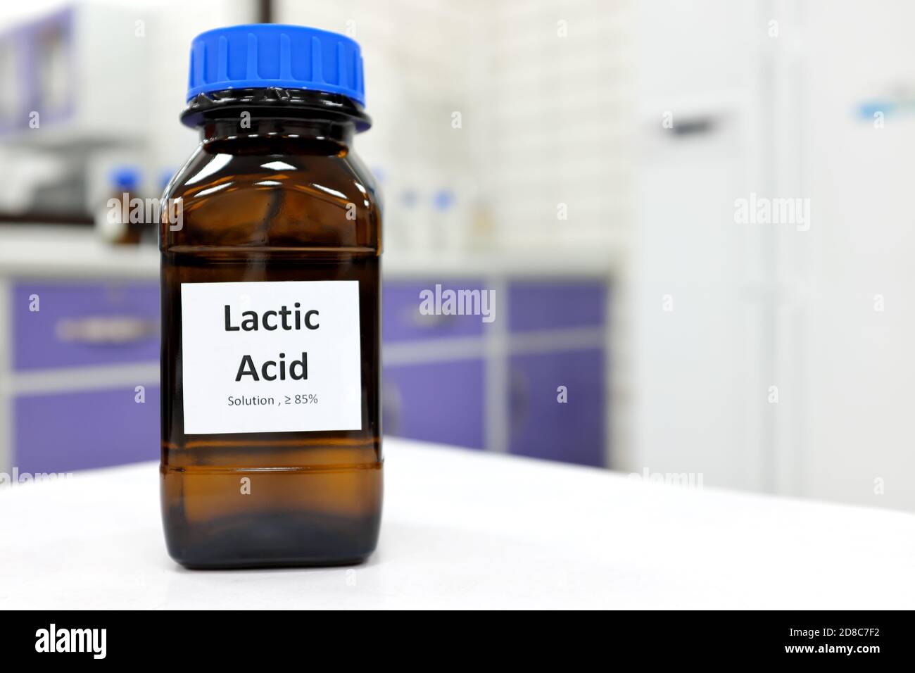 Selective focus of lactic acid liquid solution in dark brown glass ...