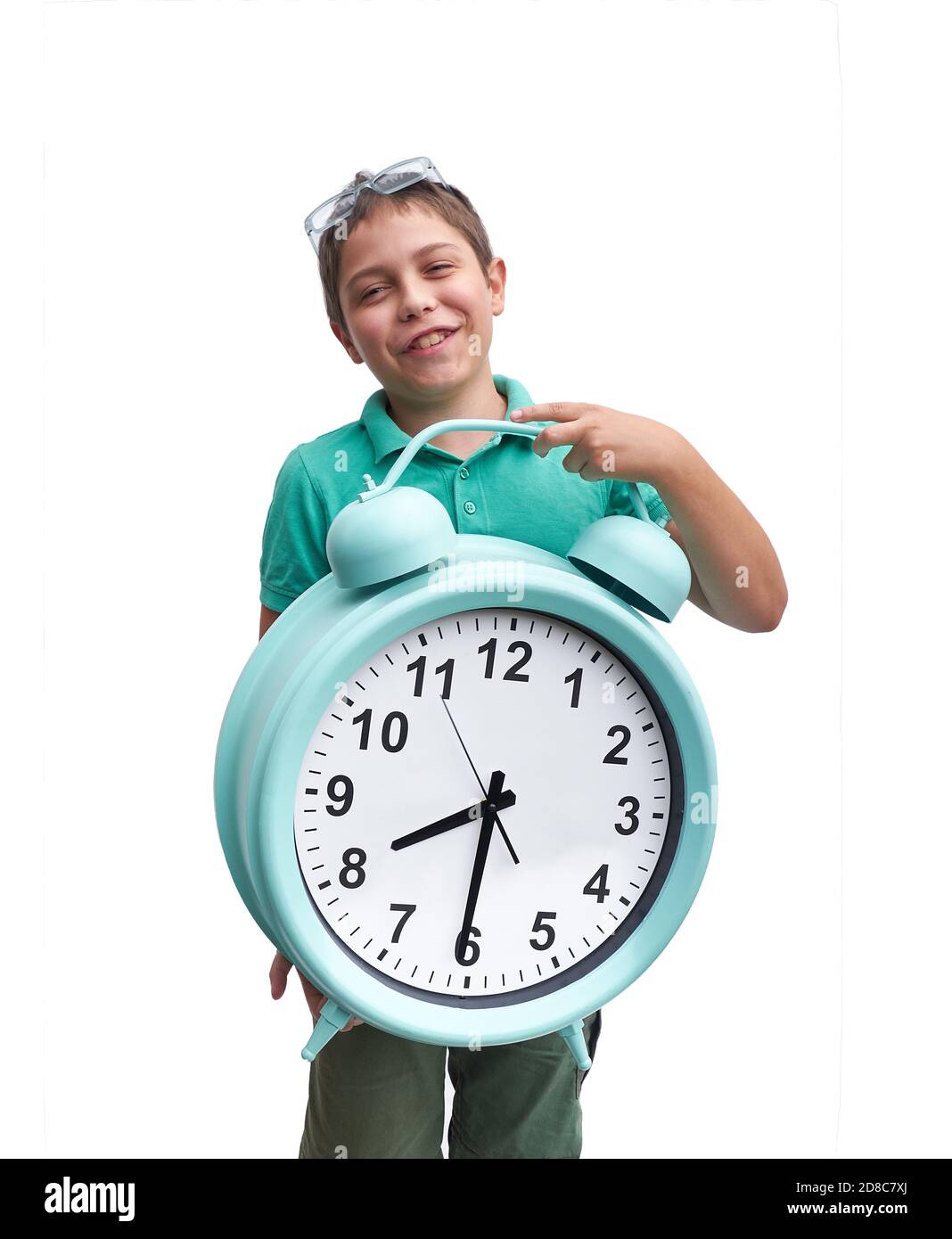 Schools start too early. Little boy with large gren alarm clock Stock ...