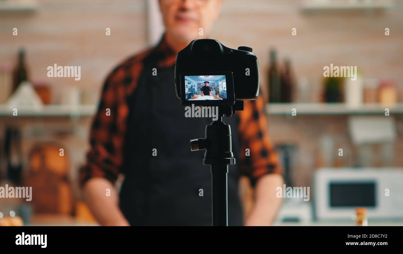 Baker presenting how using wheat flour while recording video tutorial ...
