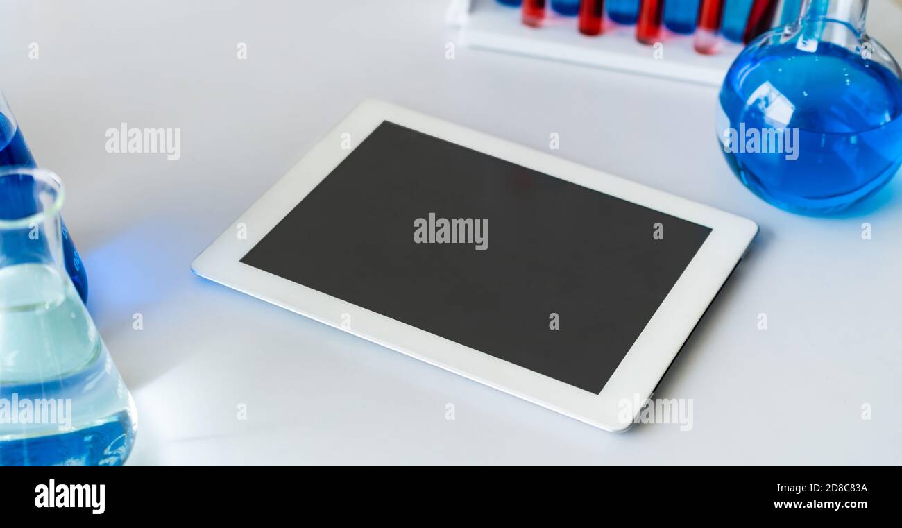 Tablet computer in laboratory and biochemistry sample in test tube ...