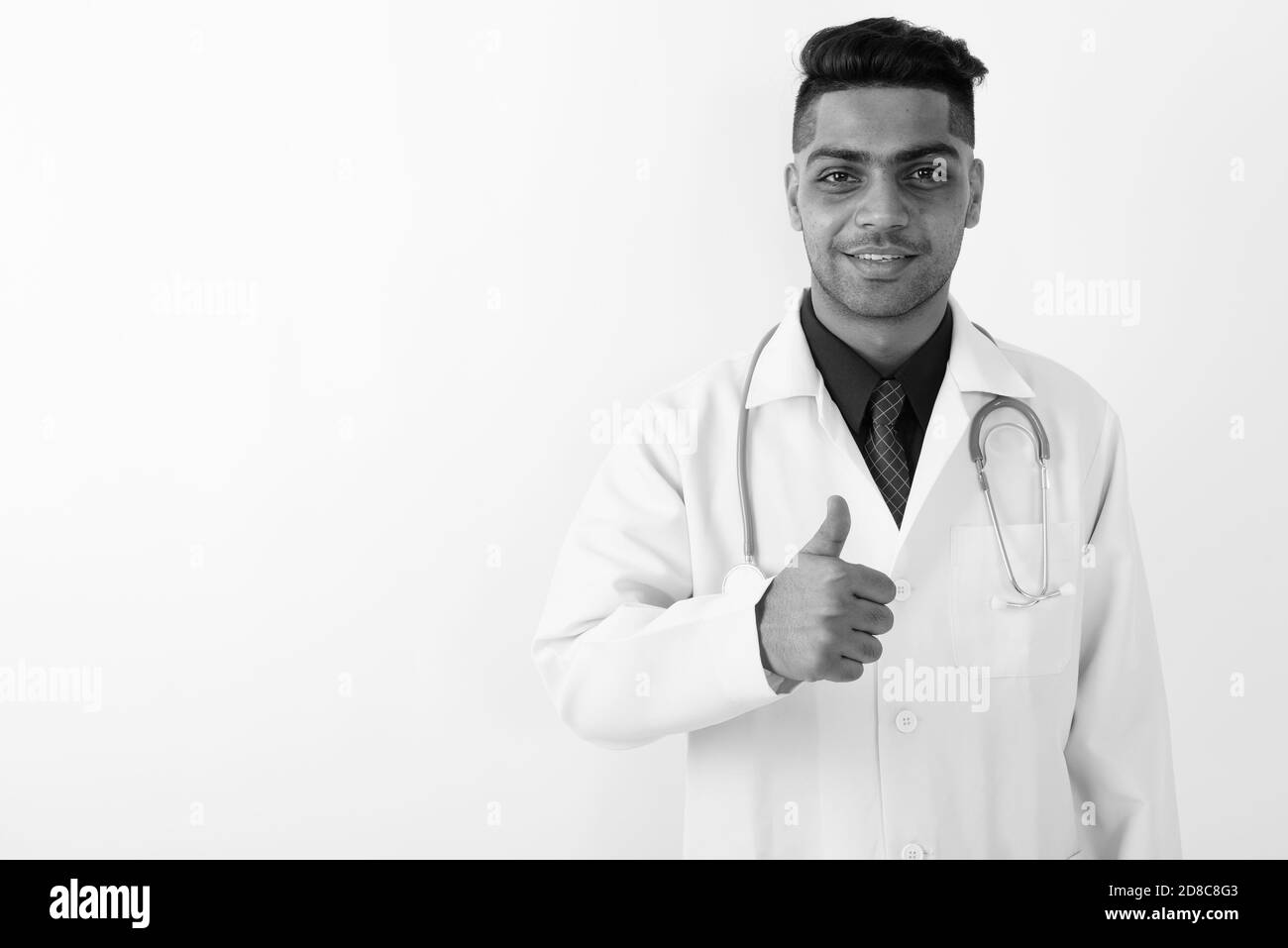 Young Indian man doctor against white background Stock Photo - Alamy