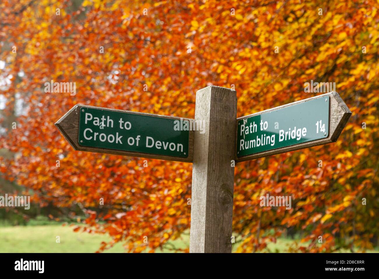 A wooden sign post pointing to Crook of Devon and Rumbling Bridge Perth ...