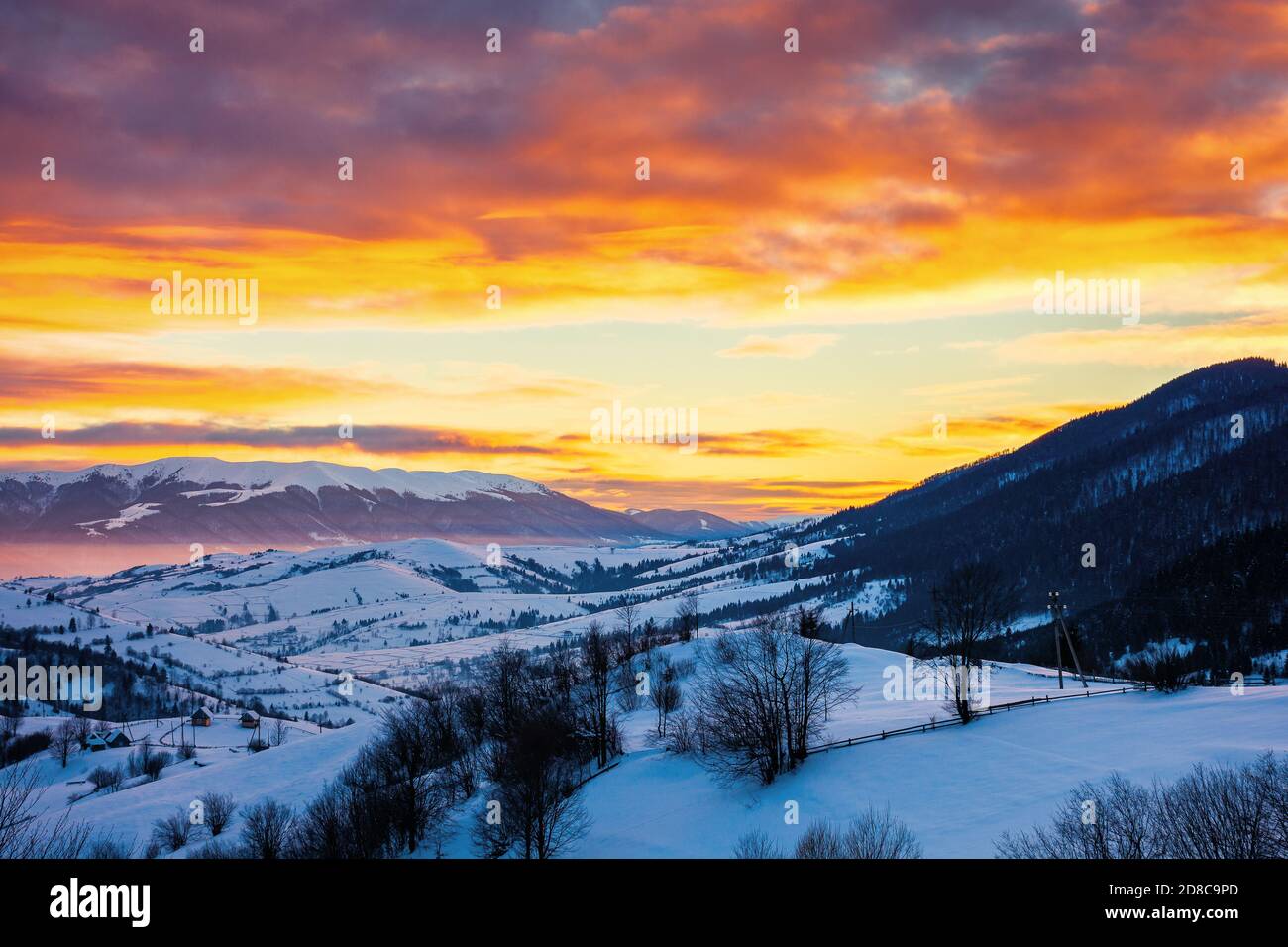 winter mountain landscape at sunrise. trees and fields on snow covered ...
