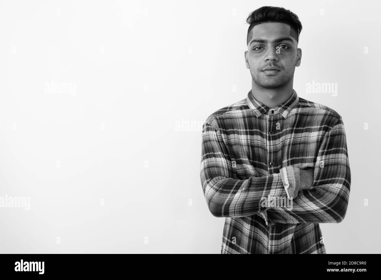 Young Indian man wearing checkered shirt against white background Stock ...