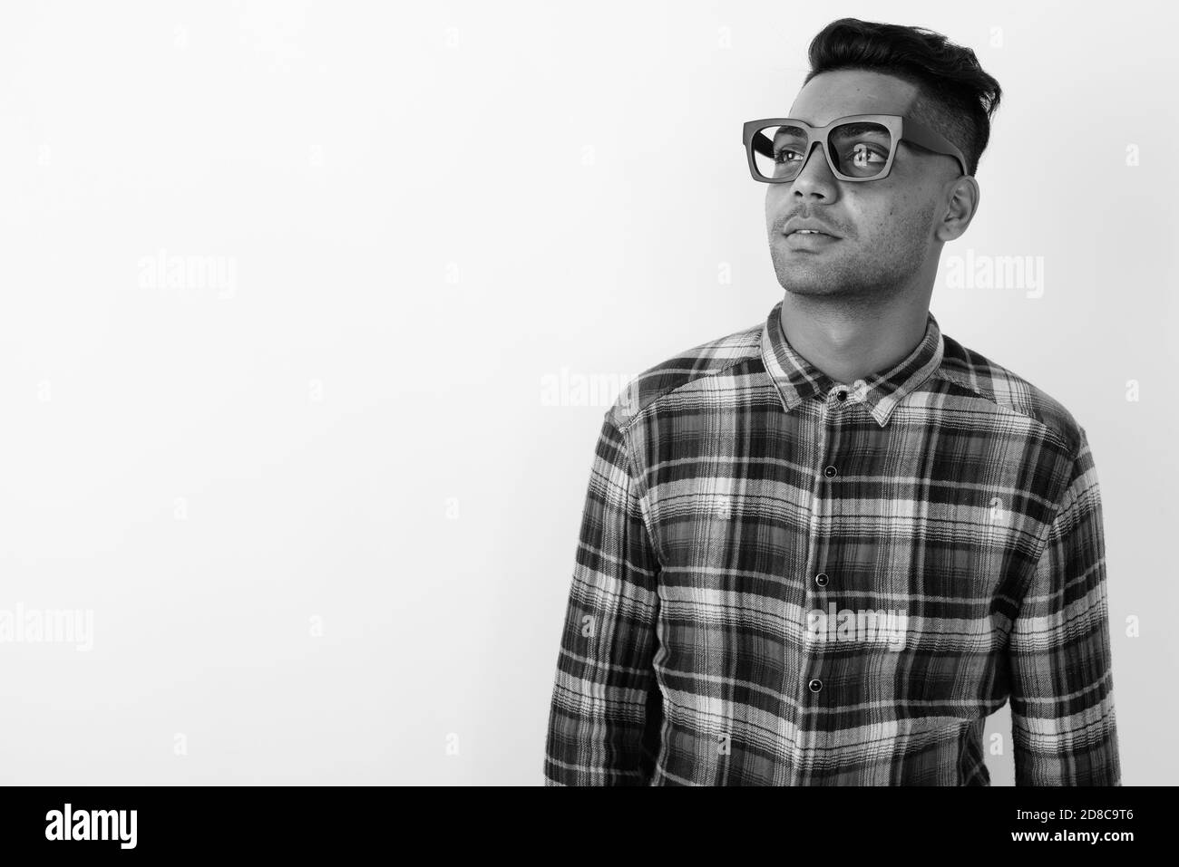 Young Indian man wearing checkered shirt against white background Stock ...