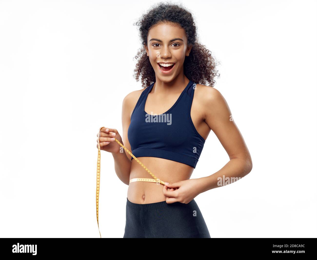Sporty woman slim figure measuring tape smile workout Stock Photo - Alamy