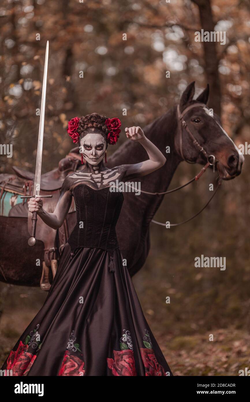 Young woman dressed as mexican symbol of day of the dead posing in ...