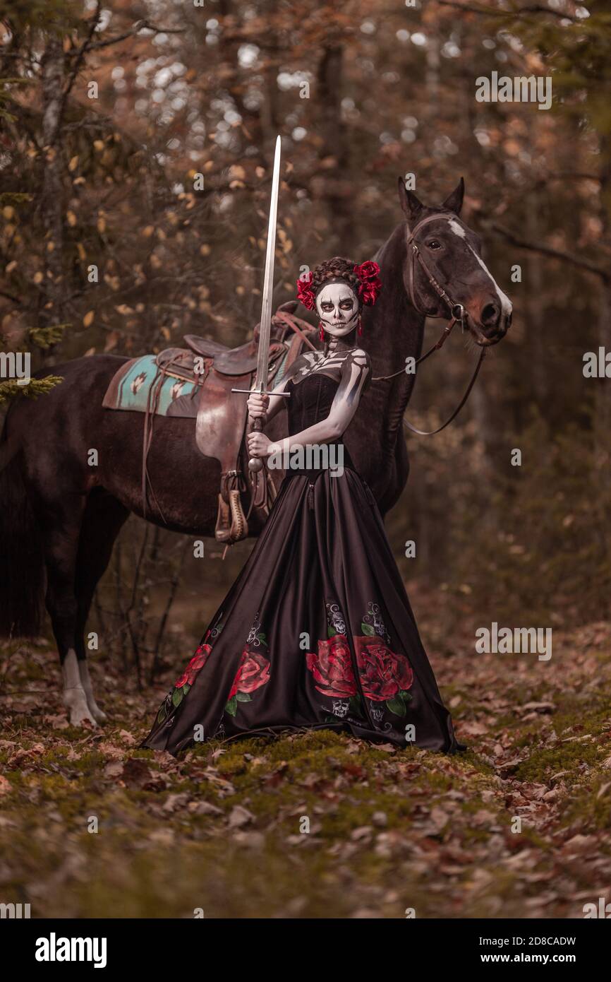 Young woman dressed as mexican symbol of day of the dead posing in ...