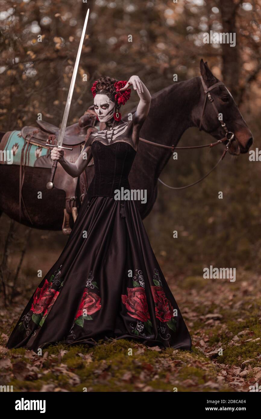 Young woman dressed as mexican symbol of day of the dead posing in ...
