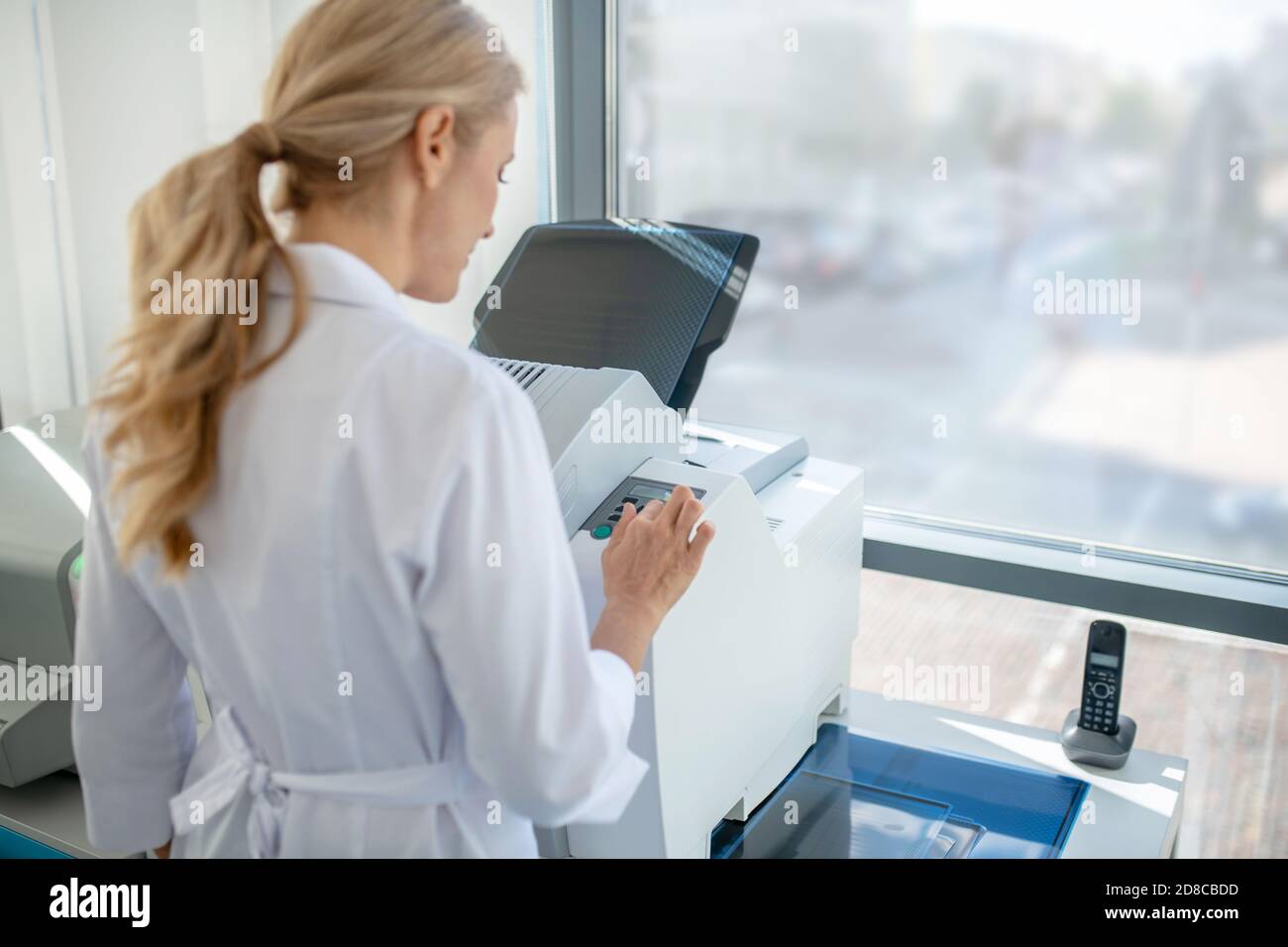Fair-haired young doctor having a busy day in clinic Stock Photo - Alamy