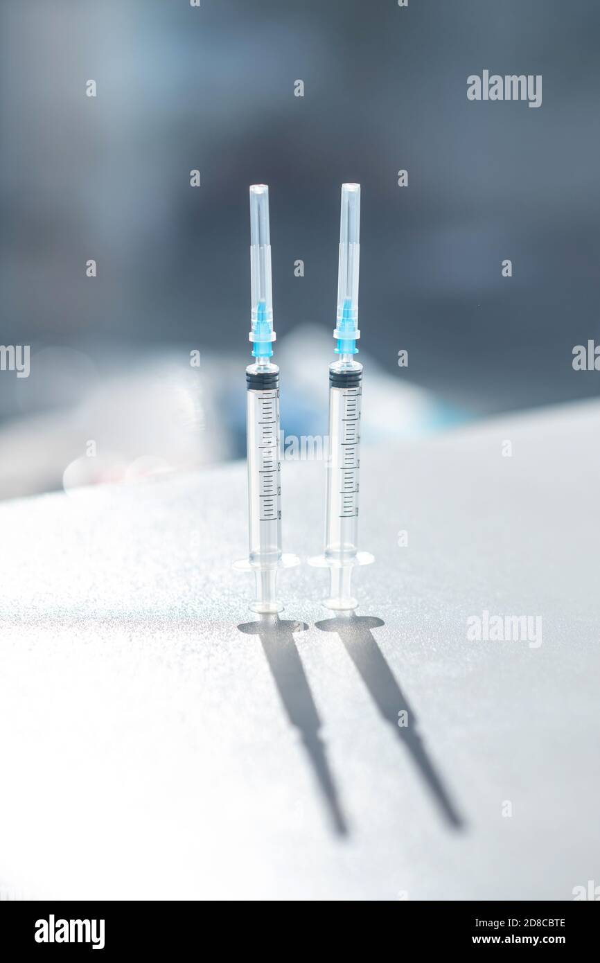 Picture of two syringes with vaccine on the table Stock Photo - Alamy