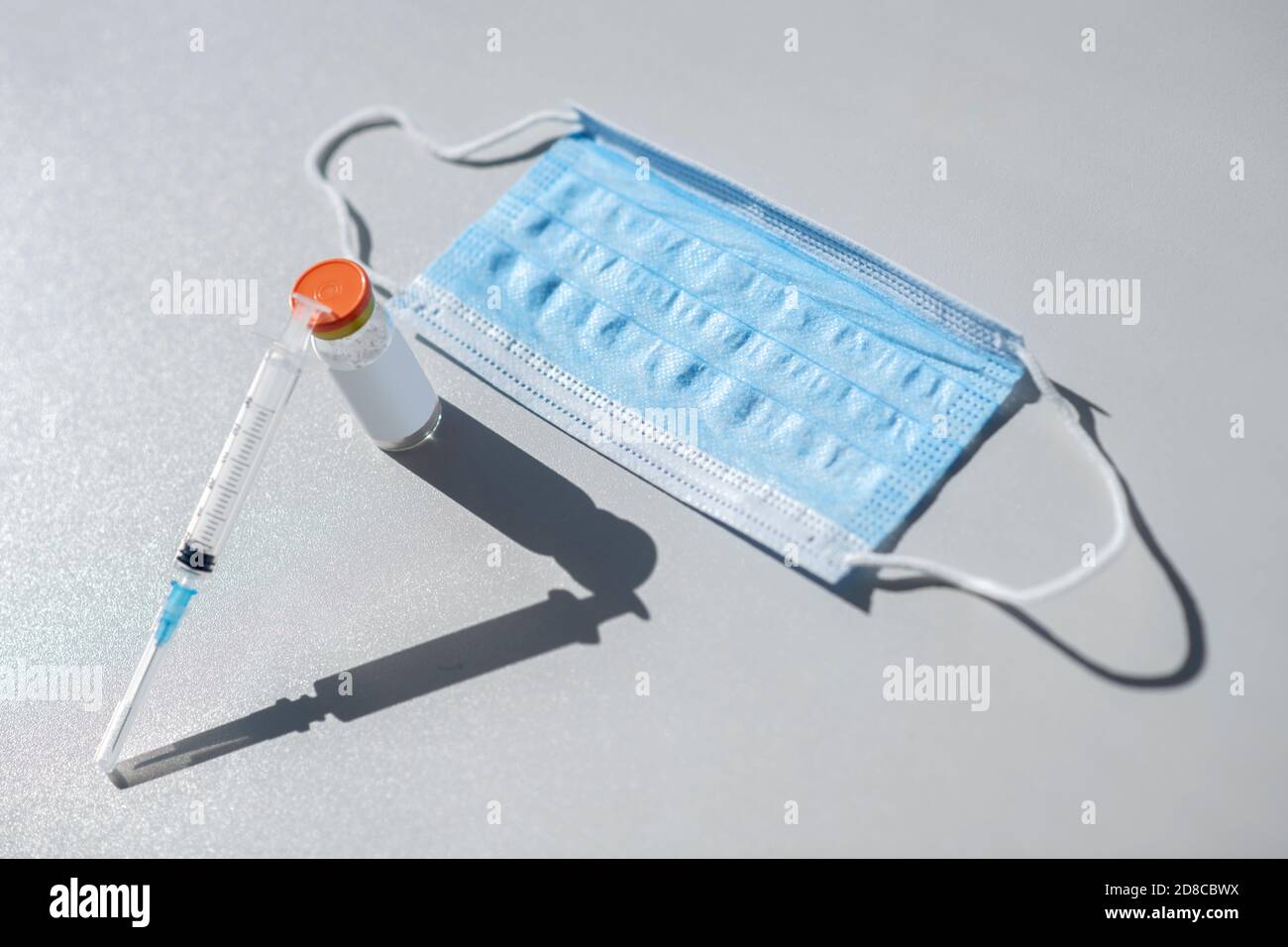 Mask, syringe and a vial on the table Stock Photo - Alamy