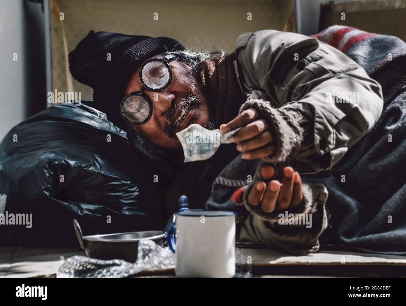 Homeless man holds money with delight after someone share him some ...