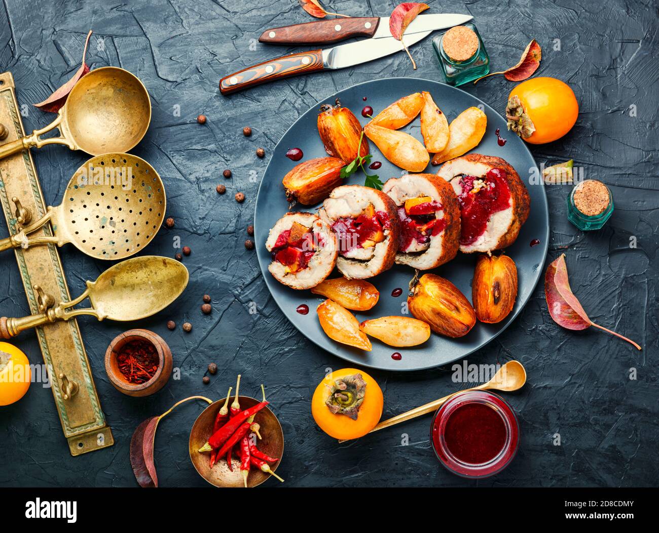 Baked pork roll with autumn persimmon.Meat stuffed with fruits.Autumn ...