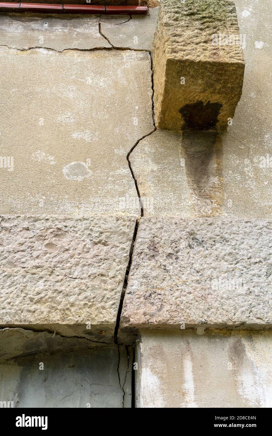 Wall crack of a destroyed building closeup. Breach from an artillery ...