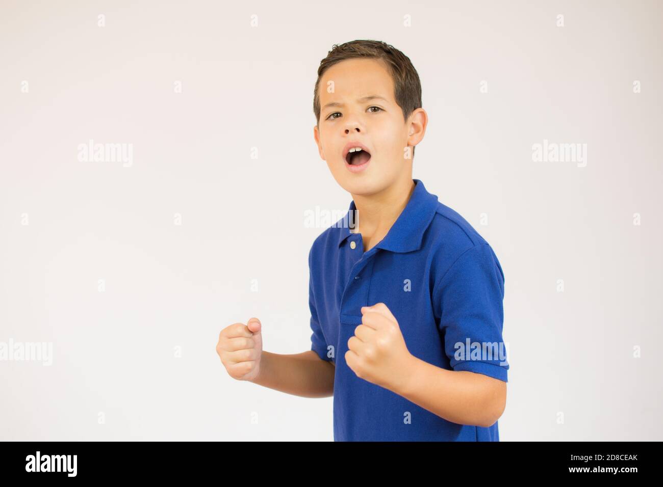 Cute little boy making a victory gesture over white background Stock ...