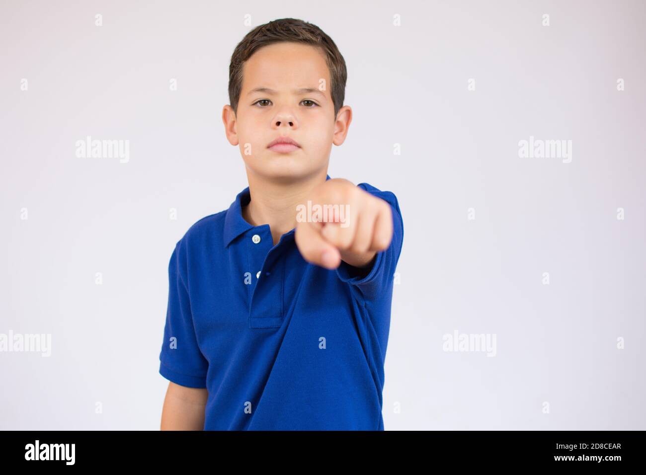 Boy standing and pointing on you over white background Stock Photo - Alamy