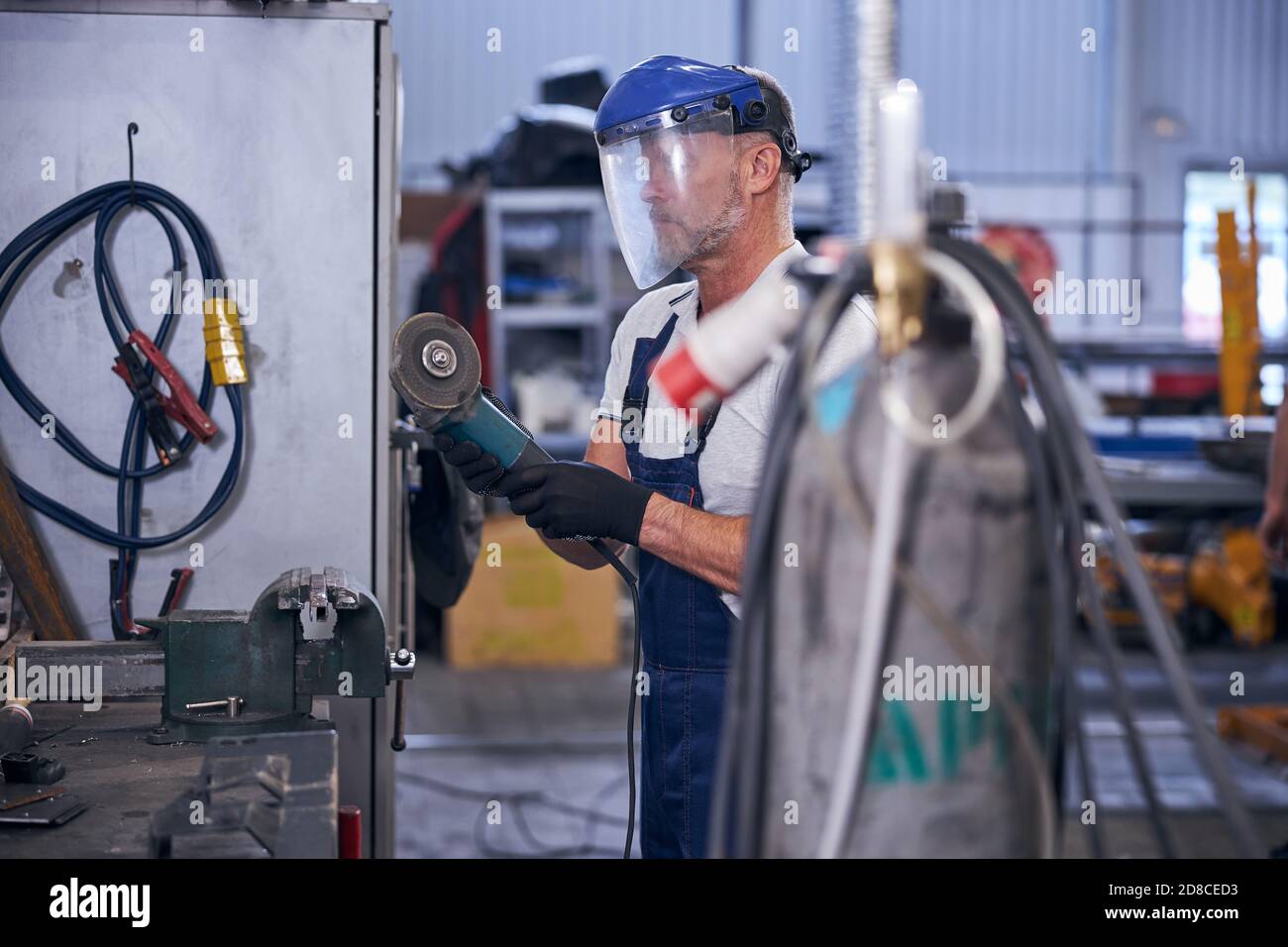 Male mechanic using grinder machine hi-res stock photography and images ...