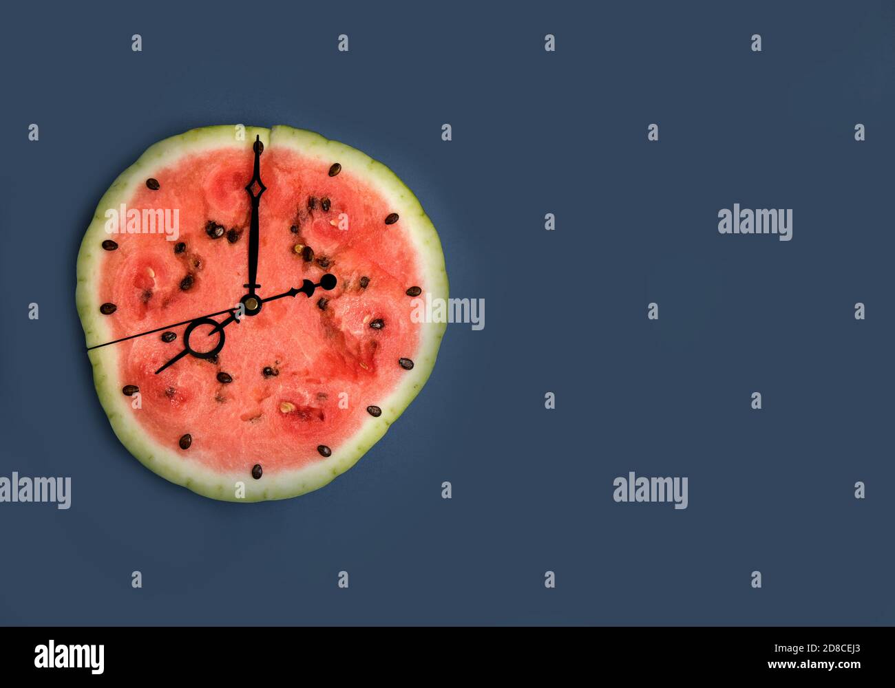 Cut of a ripe watermelon in the form of a clock, the hands show eight ...