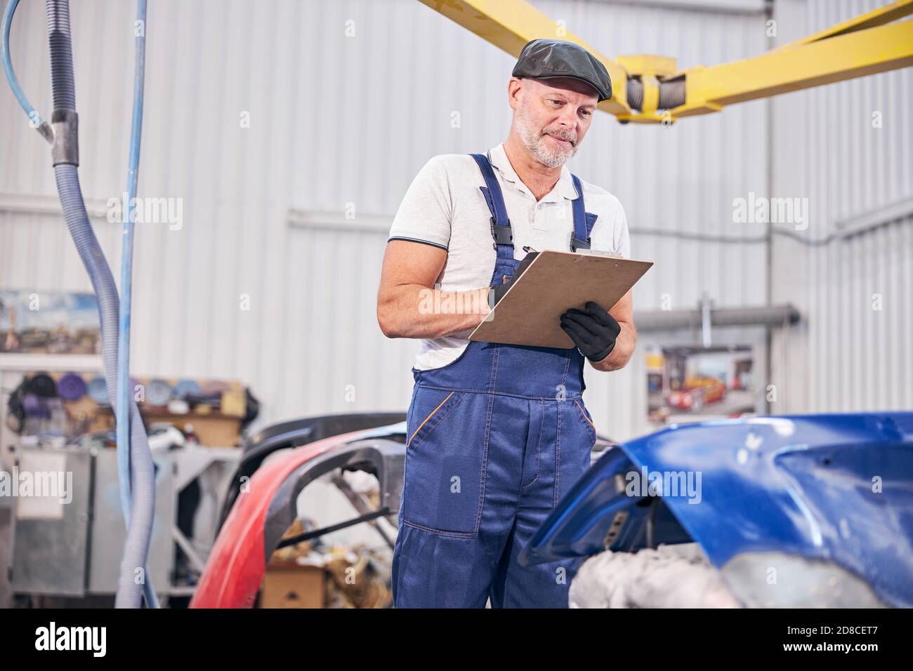 Handsome auto mechanic writing hi-res stock photography and images - Alamy