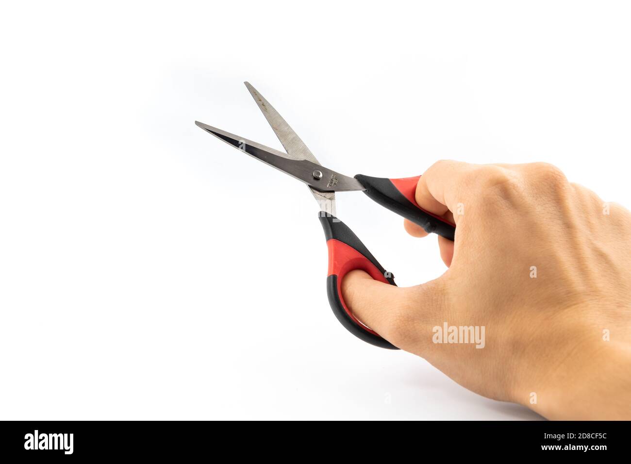 Man holding stationery scissors in hand, on white isolated background ...