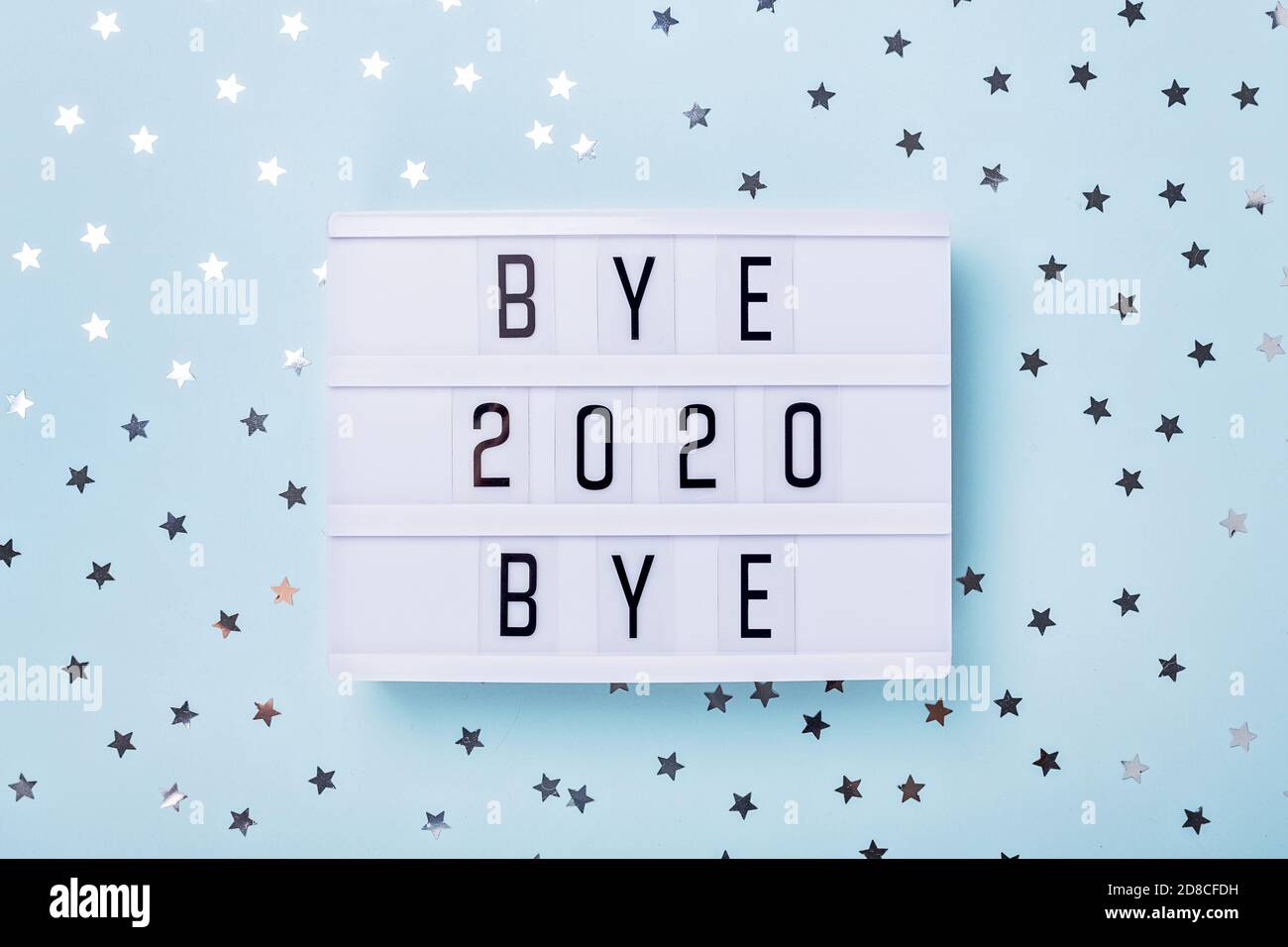 Lightbox with text BYE BYE 2020 on blue background. Top view. New year ...