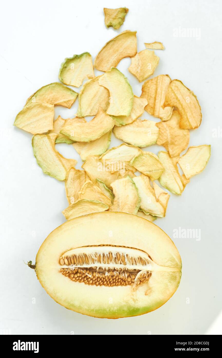 Fruit chips with melon on a white background Stock Photo - Alamy