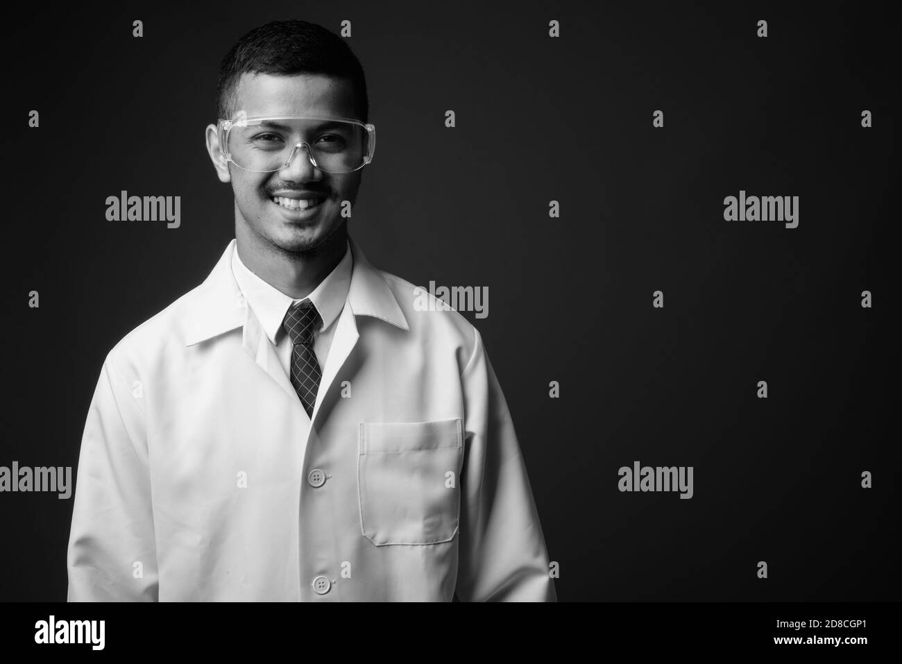 Young multi ethnic Asian man doctor against gray background Stock Photo ...