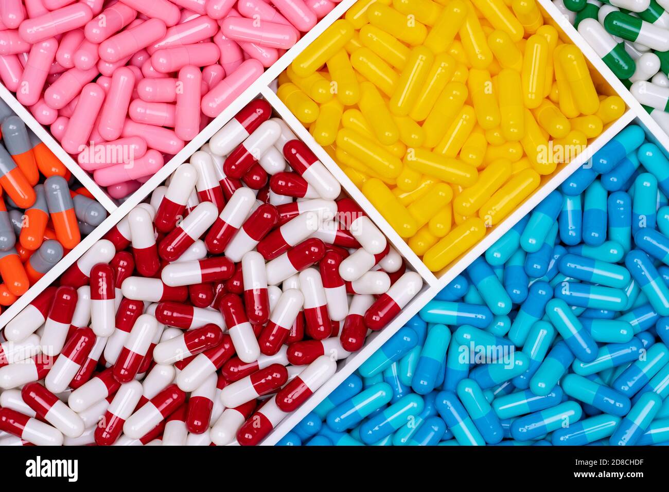 Top view of colorful capsule pills in plastic tray. Pharmaceutical ...