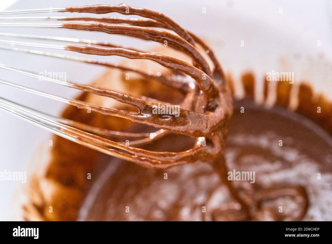 Whisking batter for chocolate cupcakes in a mixing bowl Stock Photo - Alamy