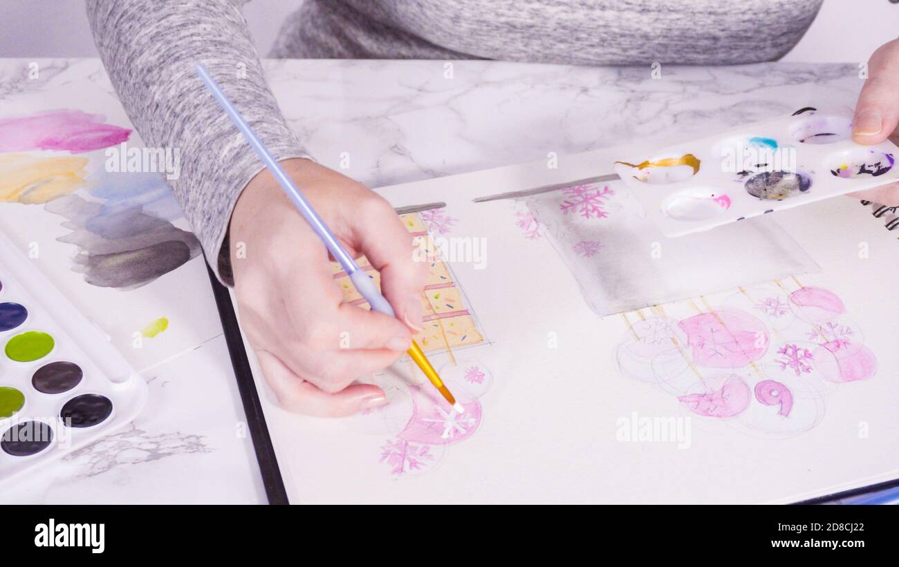 Baker is drawing the design of a birthday cake with watercolors Stock ...