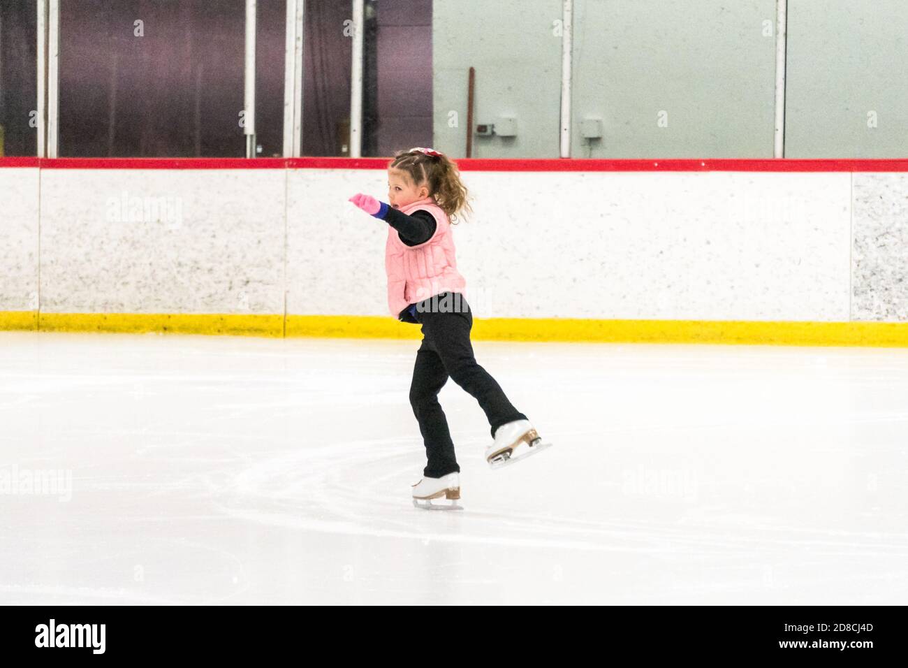 Little skater practicing her elements at the morning figure skating ...